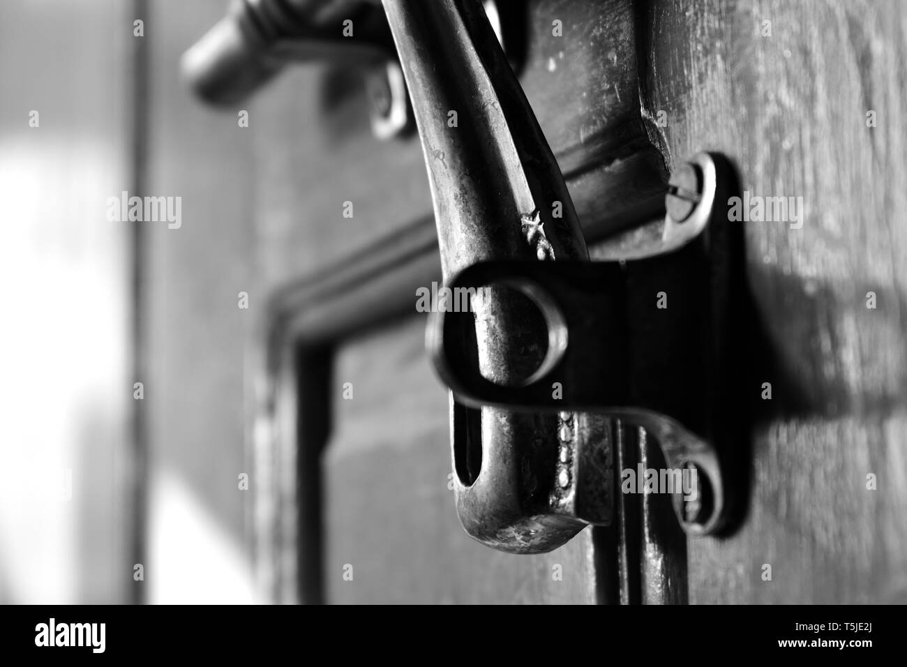 Rusted aldrop door lock on a door in Black and white close-up view ...