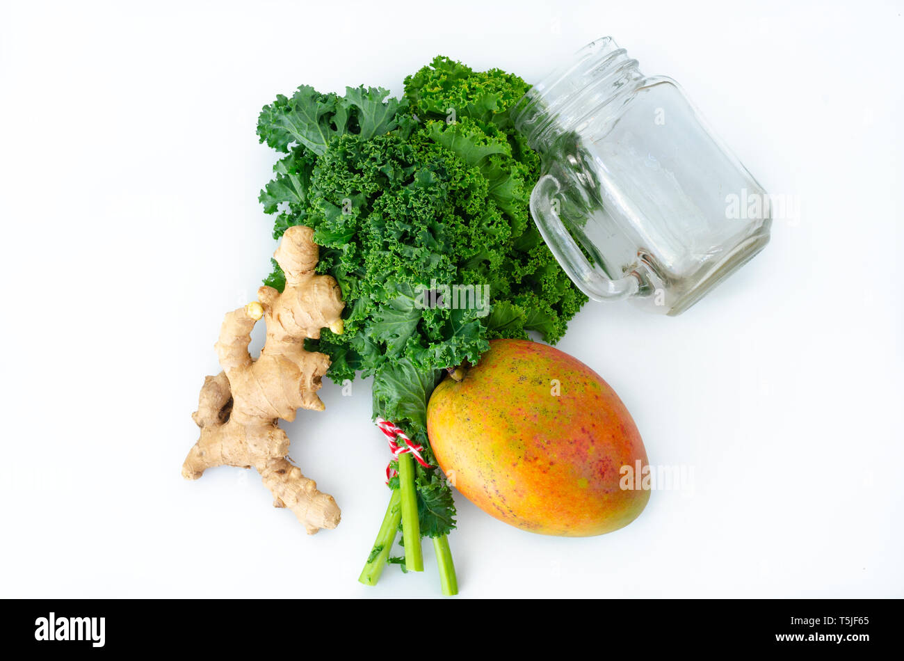 Bunch of kale with fruits on white background Stock Photo - Alamy