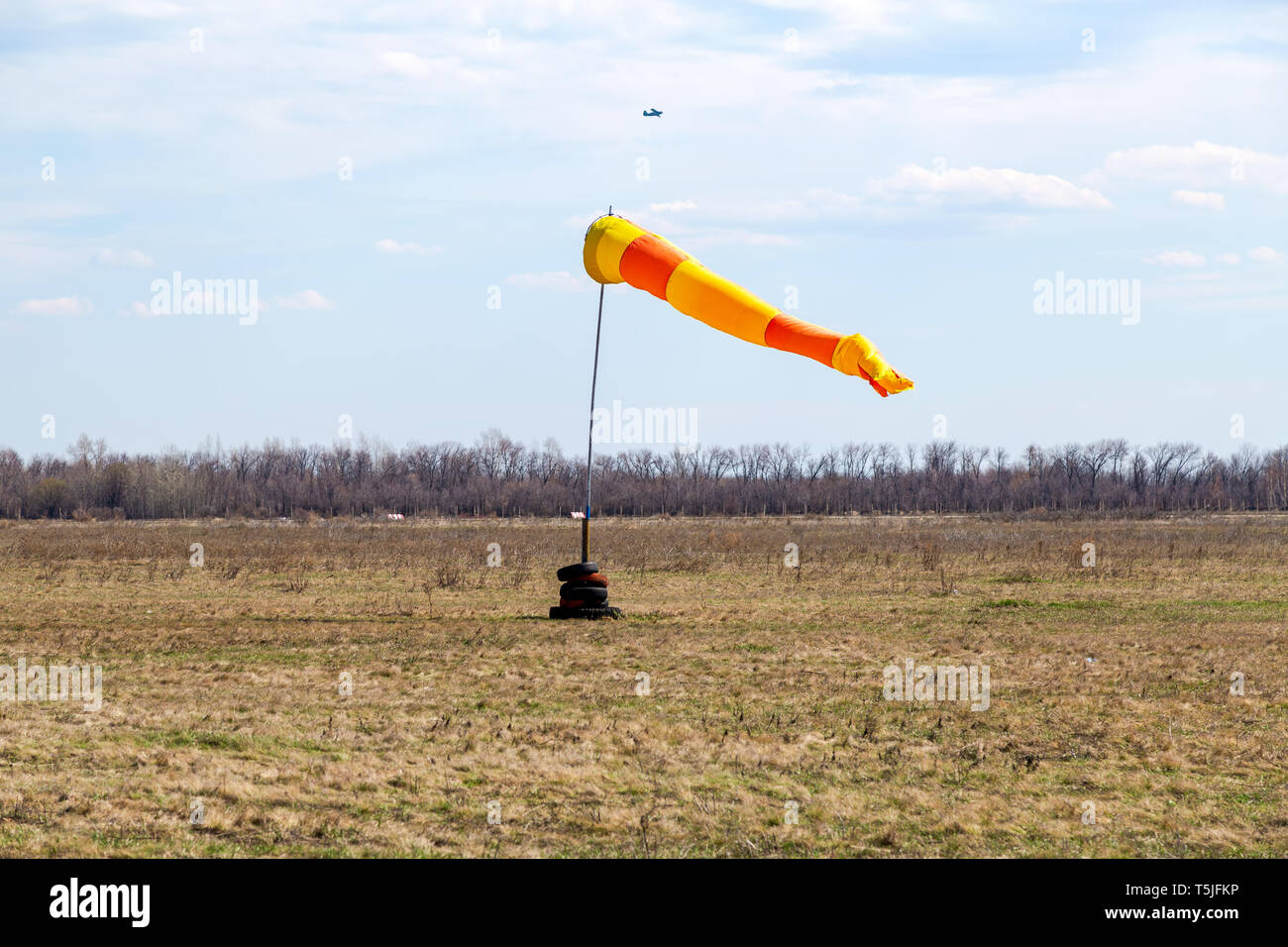 Horizontally flying windsock wind vane with red and yellow lines ...
