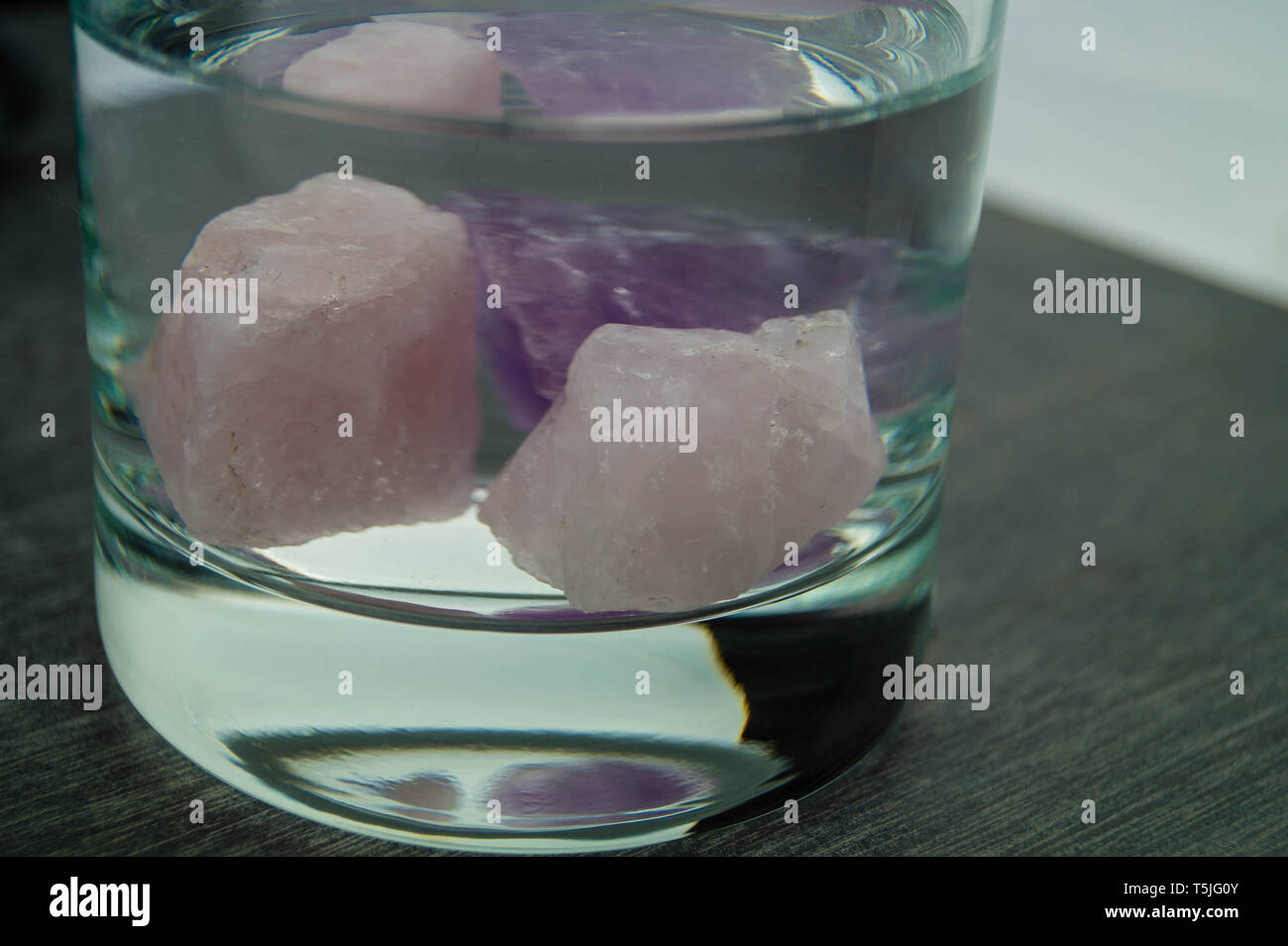 Rose quartz and Amethyst Stones to energize the drink water Stock Photo ...