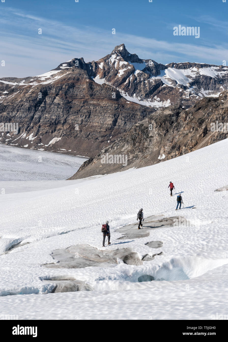 Greenland, Sermersooq, Kulusuk, Schweizerland Alps, group of people walking in snow Stock Photo ...