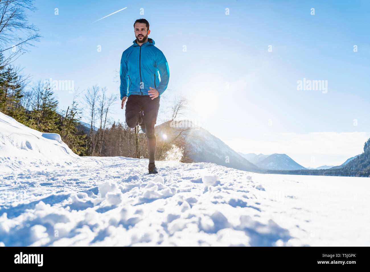 Man running through the snow hi-res stock photography and images - Alamy