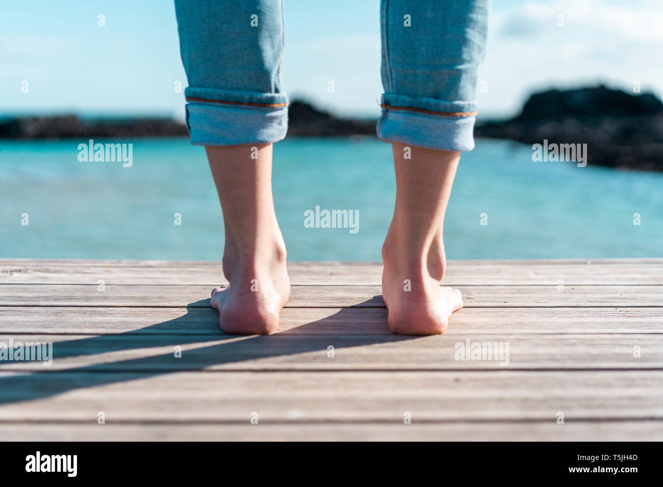 Legs woman standing jetty sea hi-res stock photography and images - Alamy