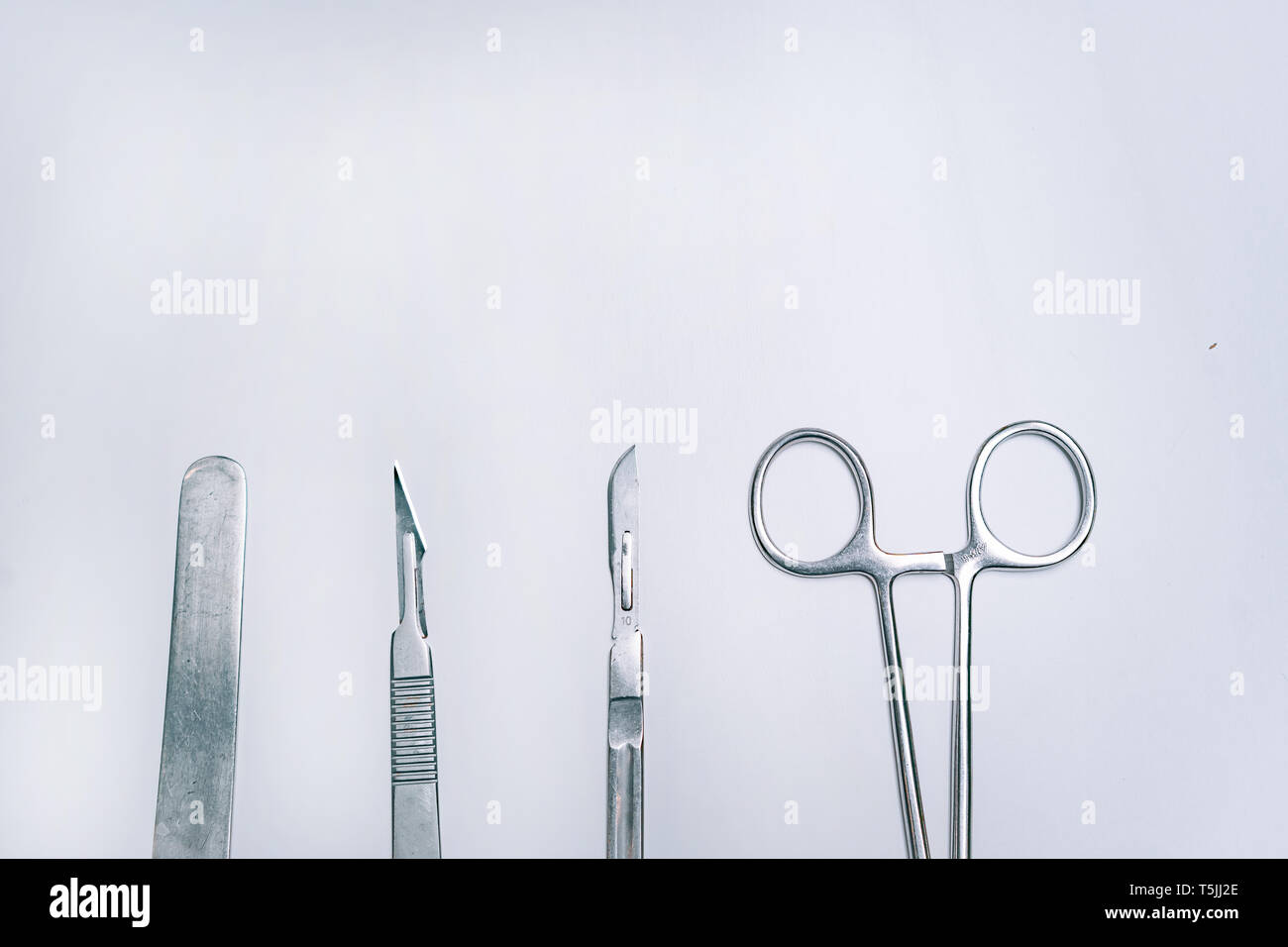 Scapula for throat, two scalpels and clamp on a light background Stock ...