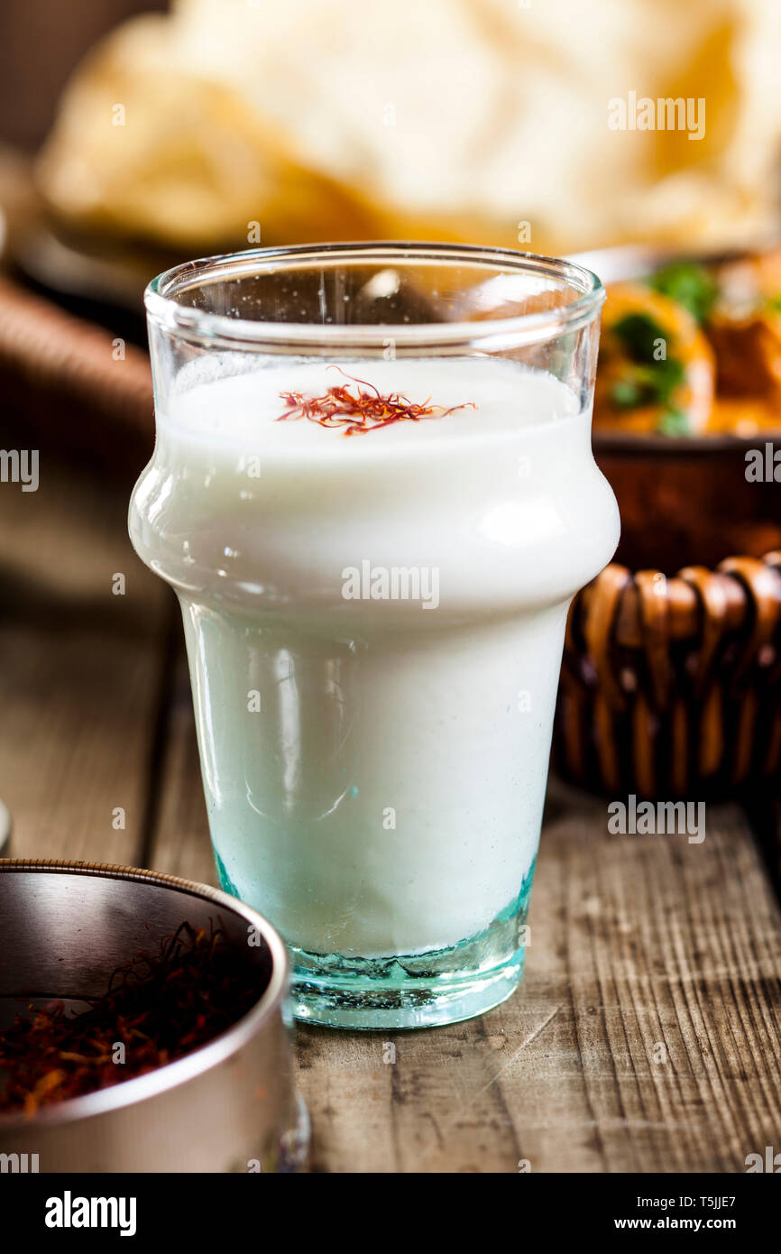 Glass of sweet Lassi with rosewater and saffron Stock Photo - Alamy