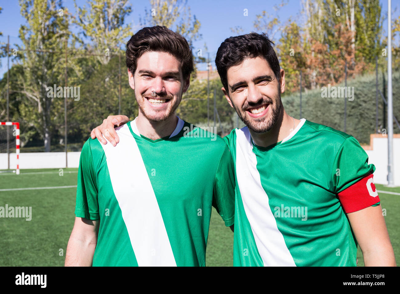 Portrait of two confident football players on football field Stock ...