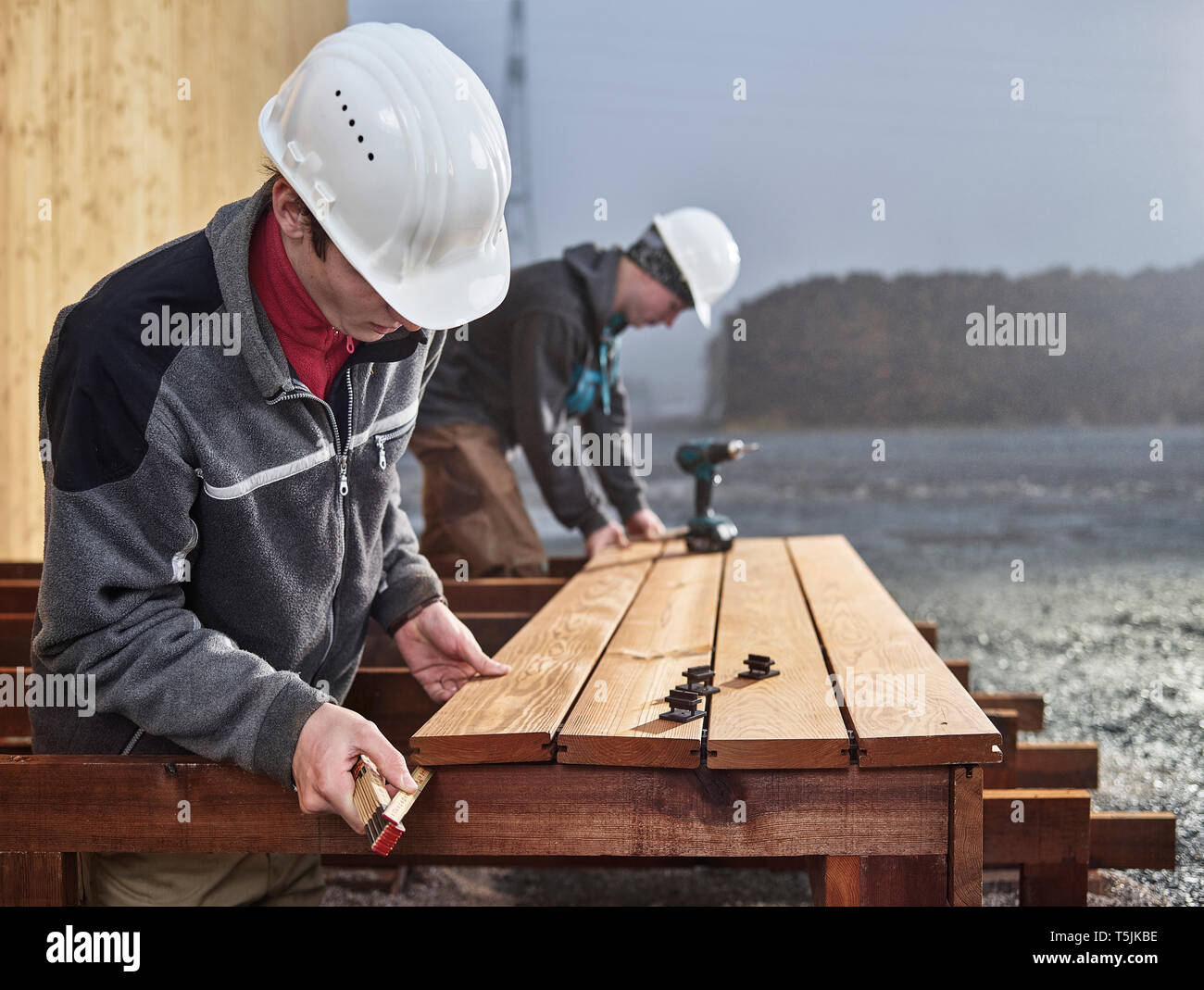 Men flooring decking board Stock Photo - Alamy