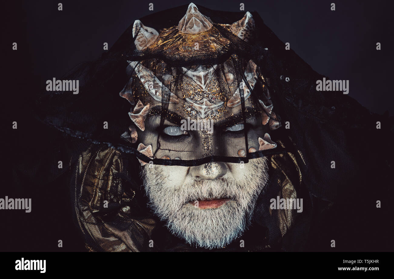 Alien, demon, sorcerer makeup. Demon on black background, close up ...