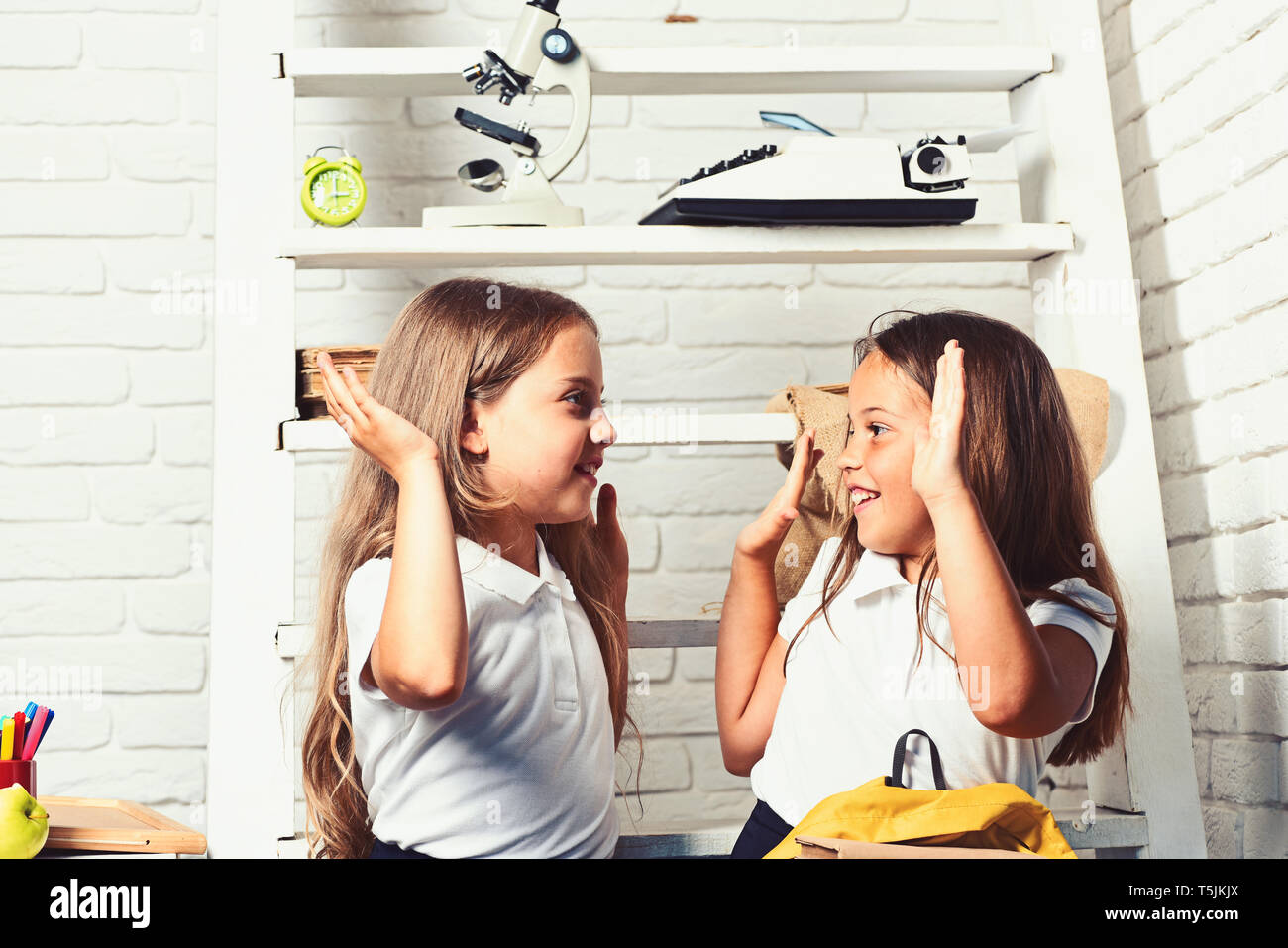 Happy cute girls play in school. First time to school. Back to school ...