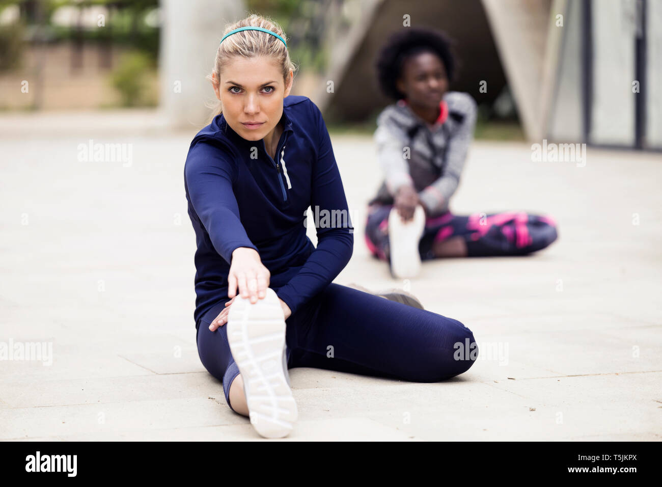 Two women stretching in hi-res stock photography and images - Alamy