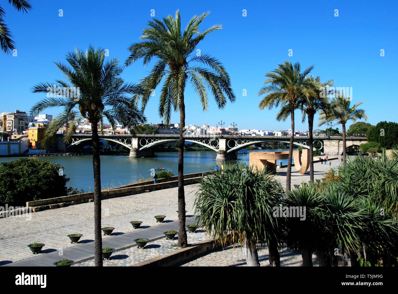 View along the Guadalquivir river with the Triana bridge to the rear ...