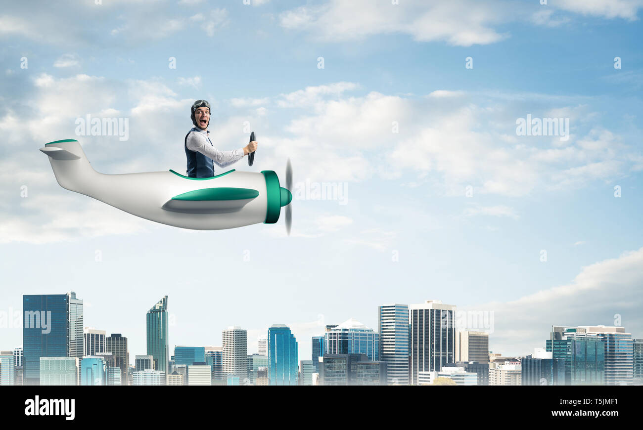 Scared pilot with open mouth in airplane Stock Photo - Alamy