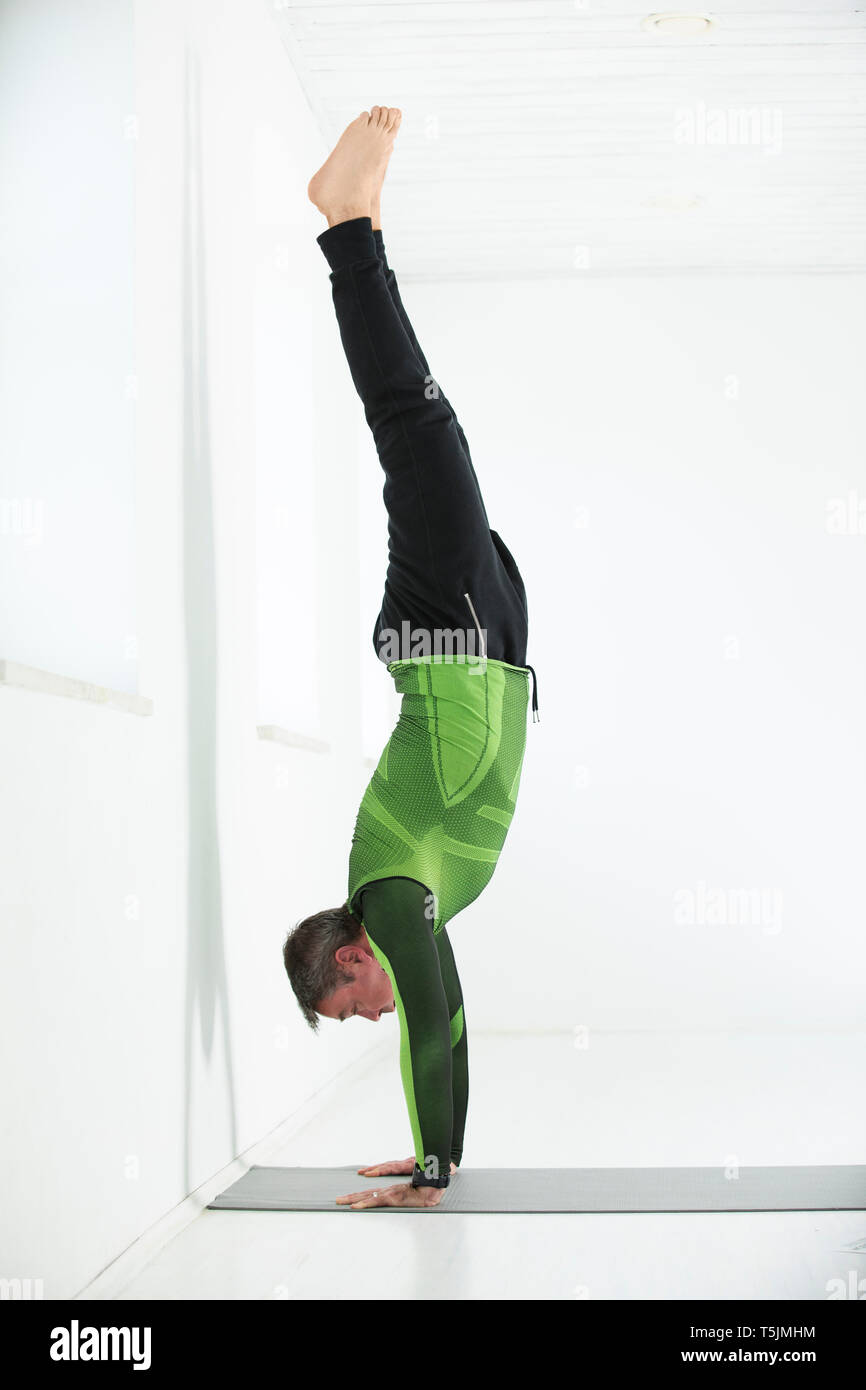 Man doing his fitness regime, practising handstand Stock Photo - Alamy