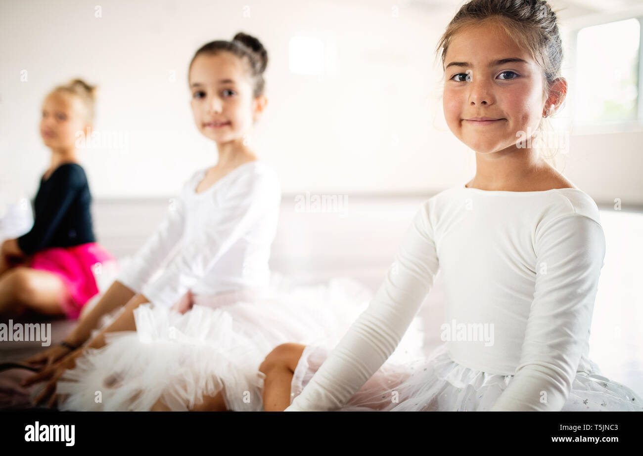 Group of fit happy children exercising ballet in studio together Stock ...