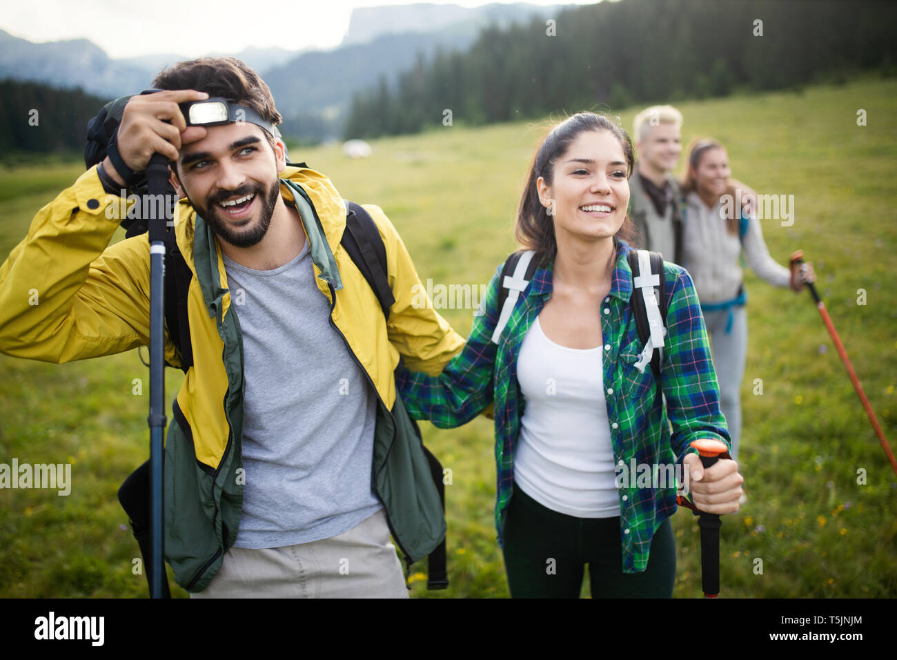 Group of young friends hiking in countryside. Multiracial young people ...