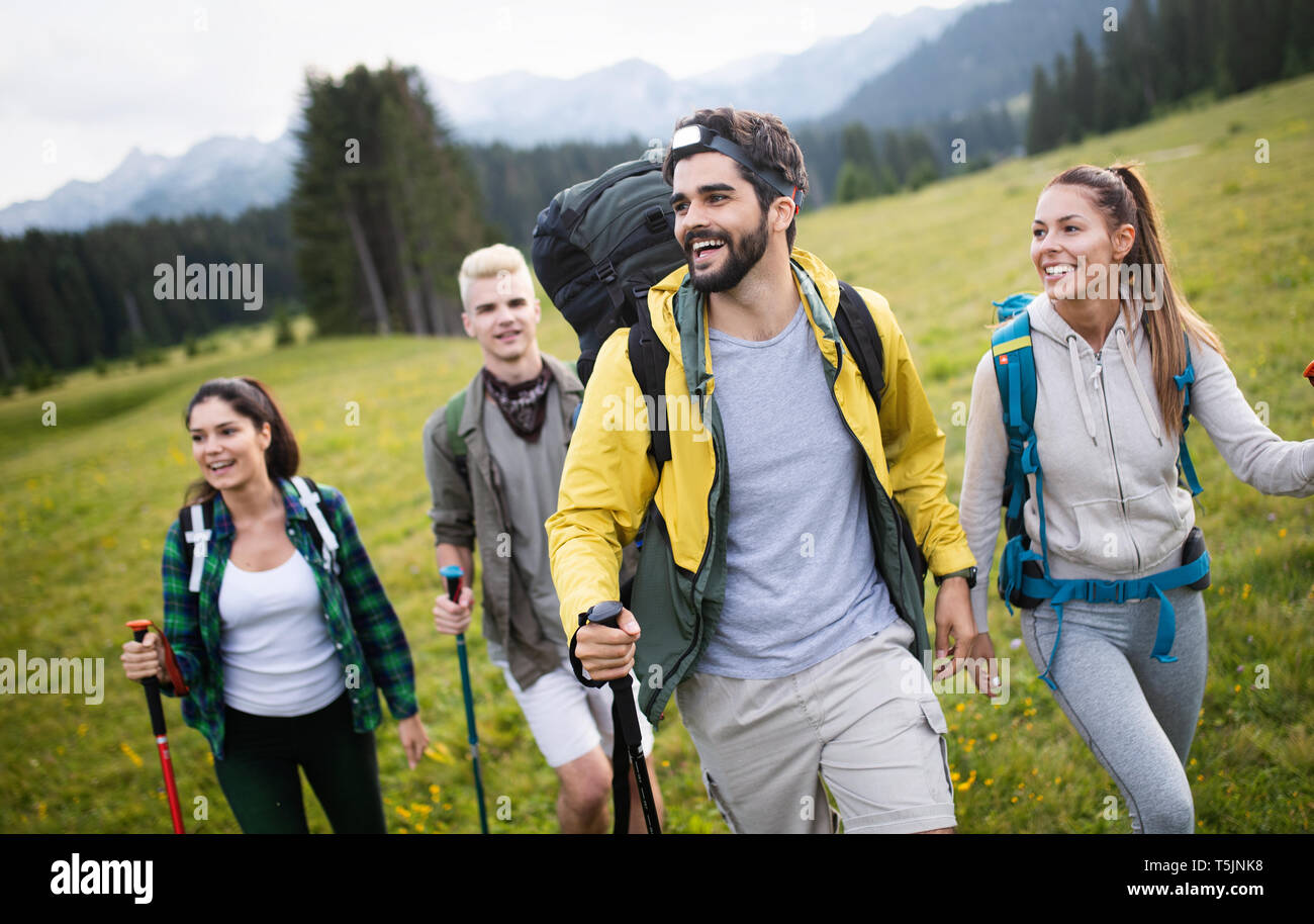 Hiking with friends is so fun. Group of young people with backpacks ...