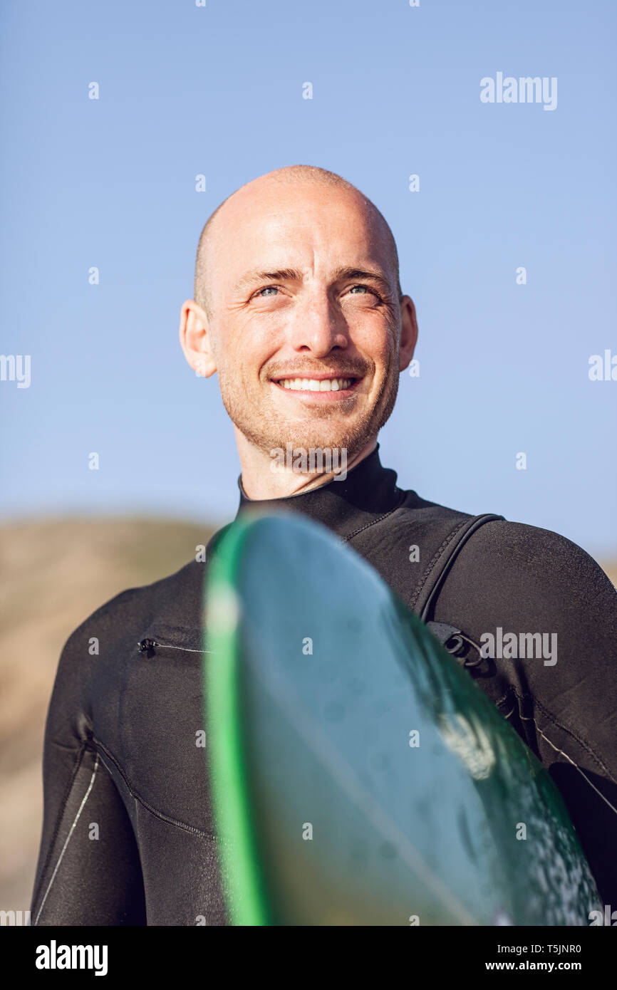 Portrait of smiling surfer with surfboard Stock Photo - Alamy