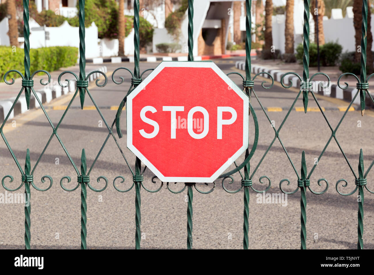 closed gate with a red stop sign at the entrance to the hotel Stock ...