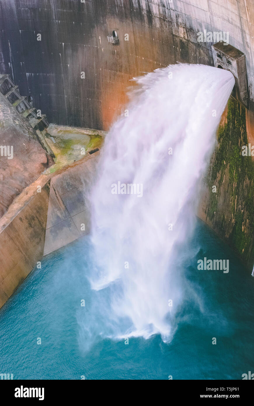 massive volume of water falling from dam gates Stock Photo - Alamy