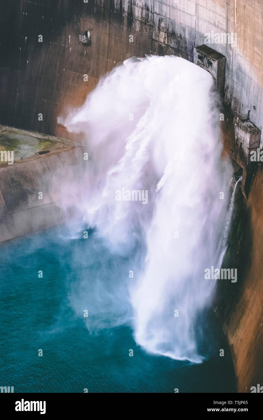 massive volume of water falling from dam gates Stock Photo - Alamy