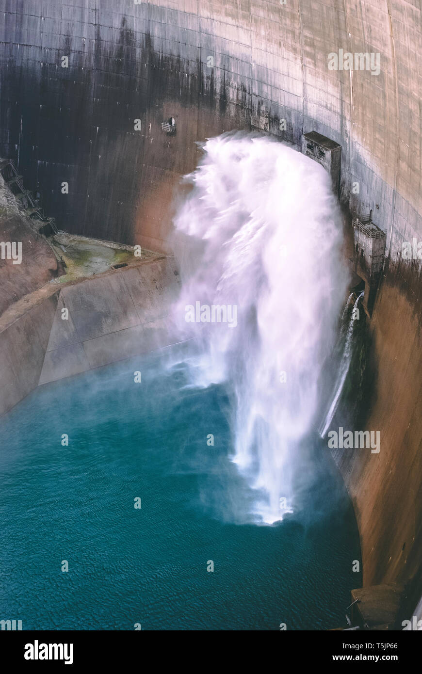 massive volume of water falling from dam gates Stock Photo - Alamy