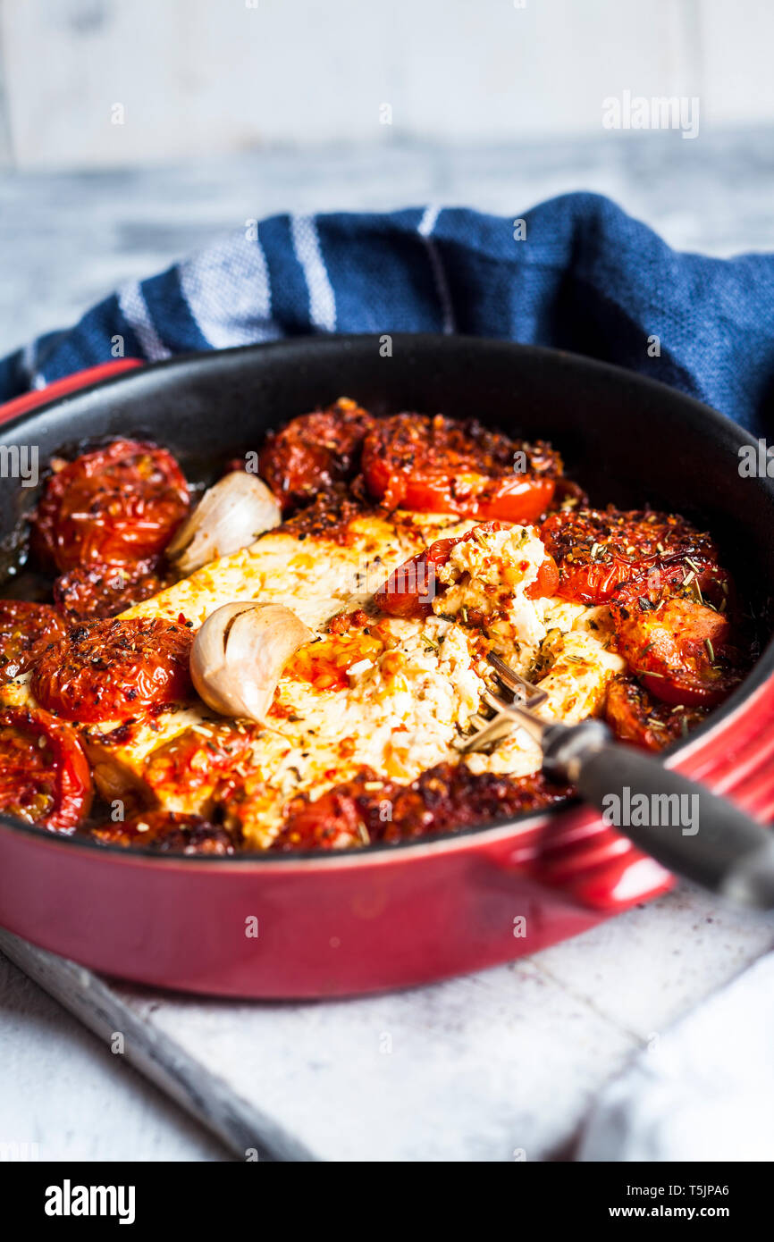 Grilled feta cheese with tomatoes and garlic Stock Photo - Alamy