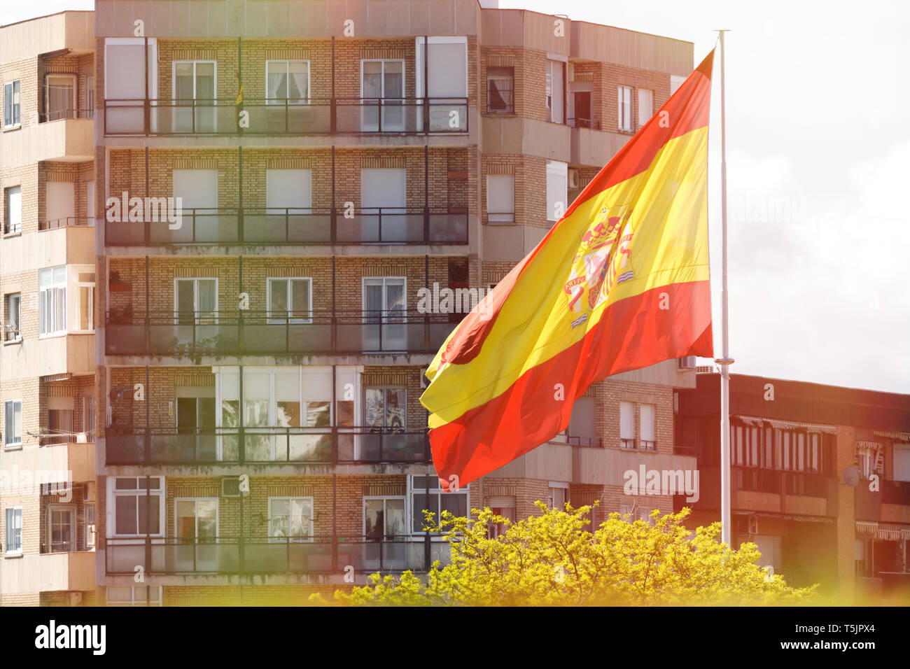 Spain flag waving in the wind in a city Stock Photo - Alamy
