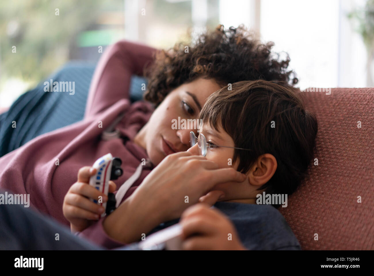 Cuddling on couch hi-res stock photography and images - Alamy
