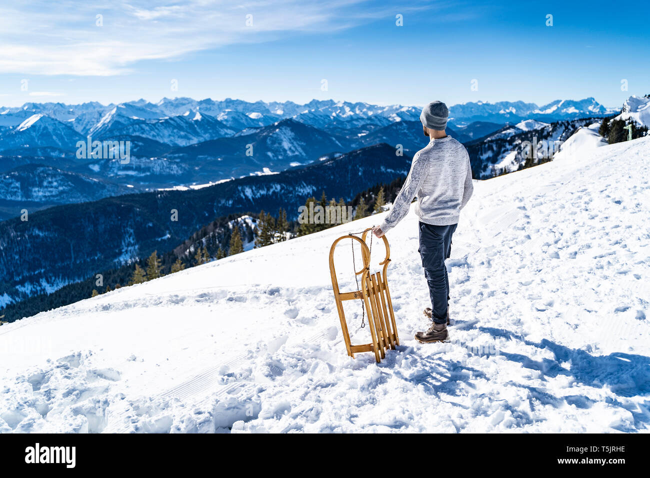 Man sledge winter mountains looking view hi-res stock photography and ...