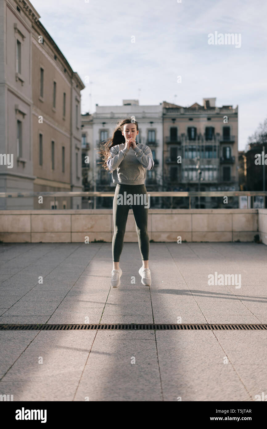 Woman jumping on terrace hi-res stock photography and images - Alamy