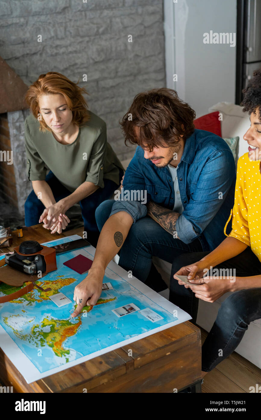Friends meeting to plan vacations, checking map Stock Photo - Alamy