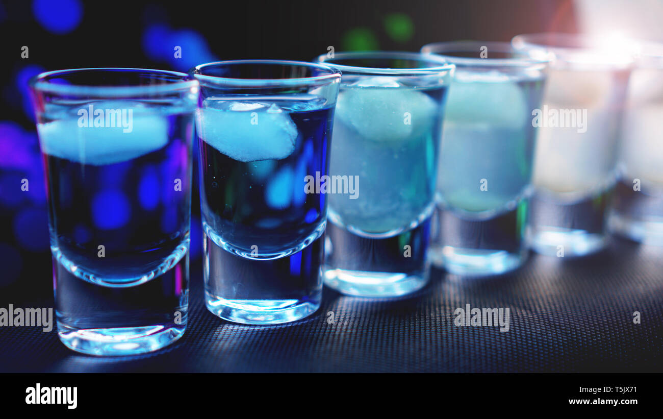 Glasses of vodka with ice. In bar - neon background Stock Photo - Alamy