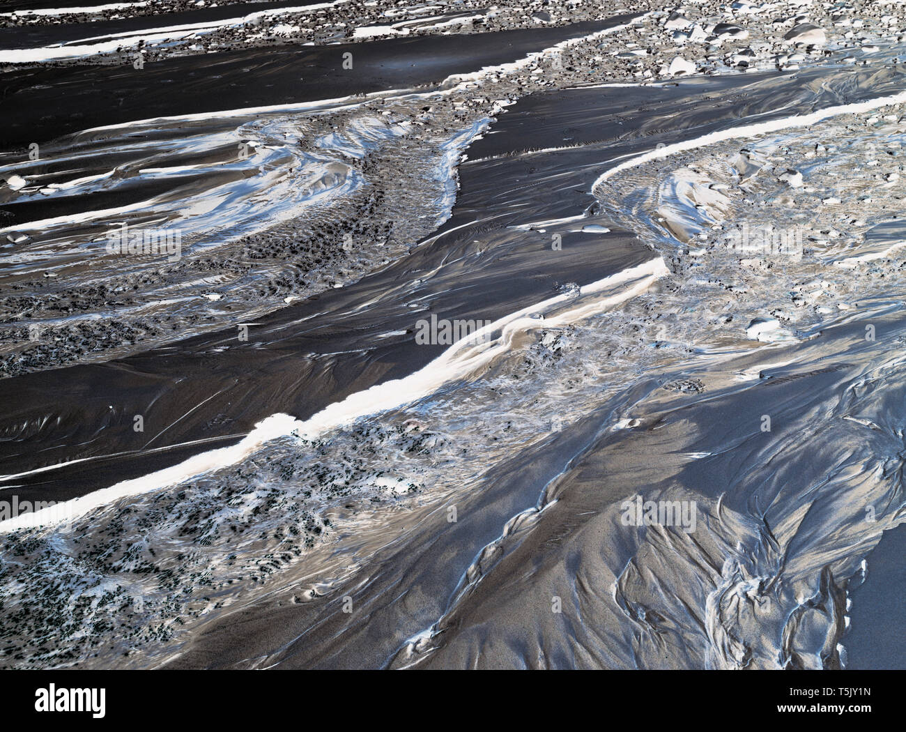 Inverted abstract image of small intertidal stream on beach, sand and ...