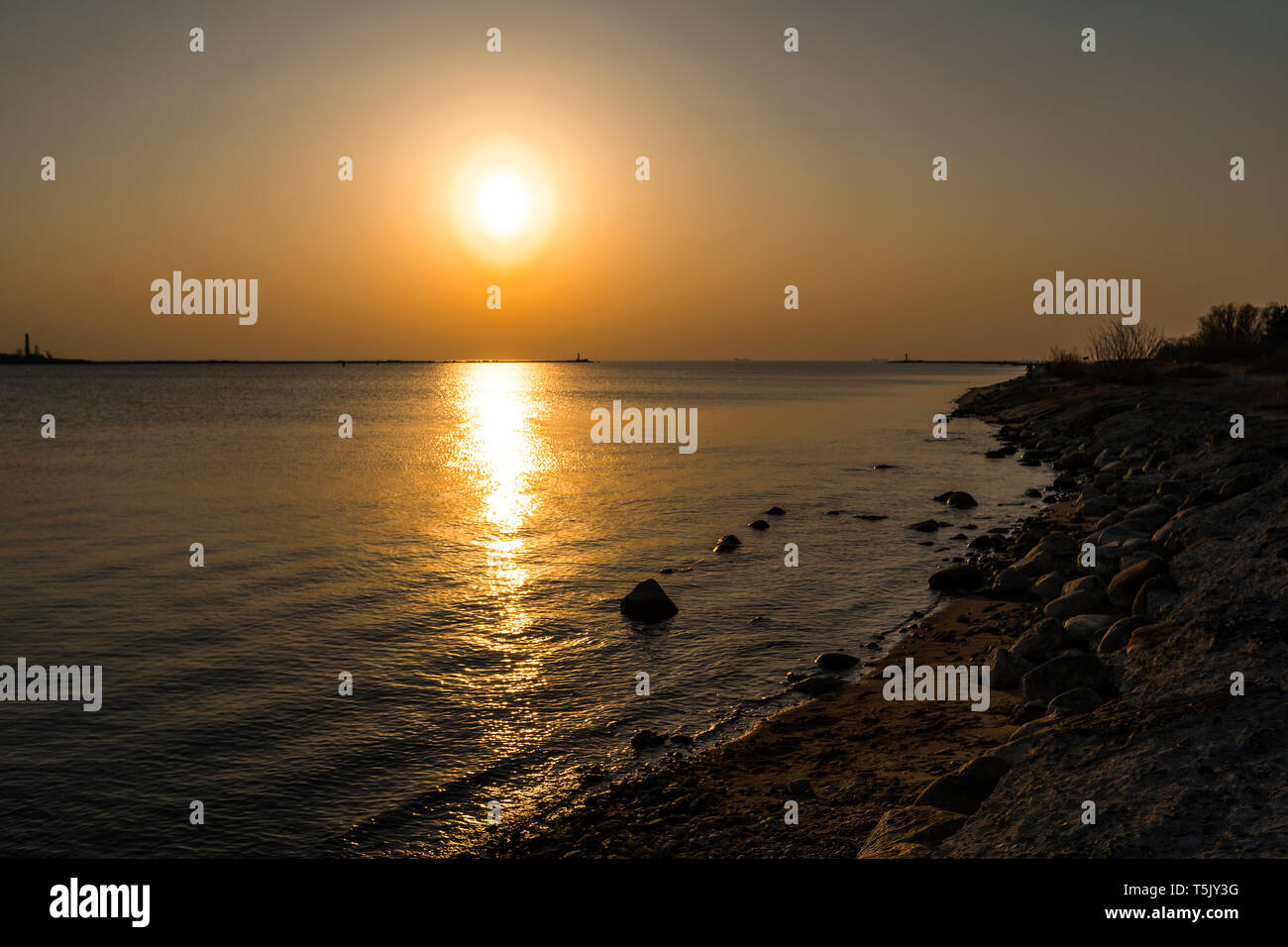 Boulder beach sunset with clear sky and beautiful vivid warm colors ...