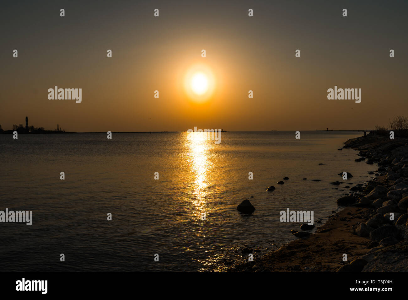 Boulder beach sunset with clear sky and beautiful vivid warm colors ...