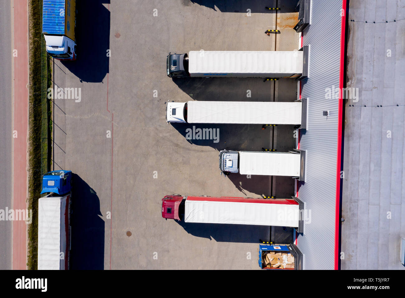 Aerial Side Shot of Industrial Warehouse Loading Dock where Many Truck ...