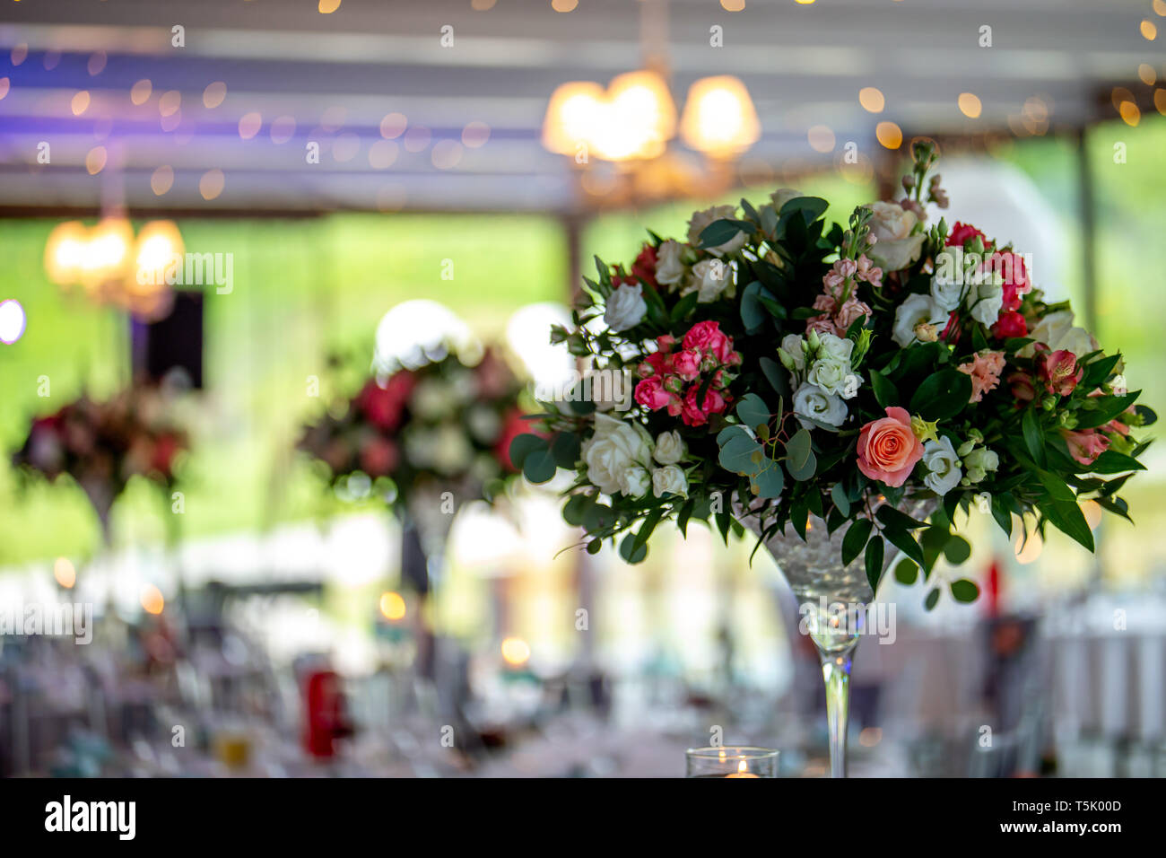 Wedding table decoration. Beautiful bouquet of flowers in vase on the ...