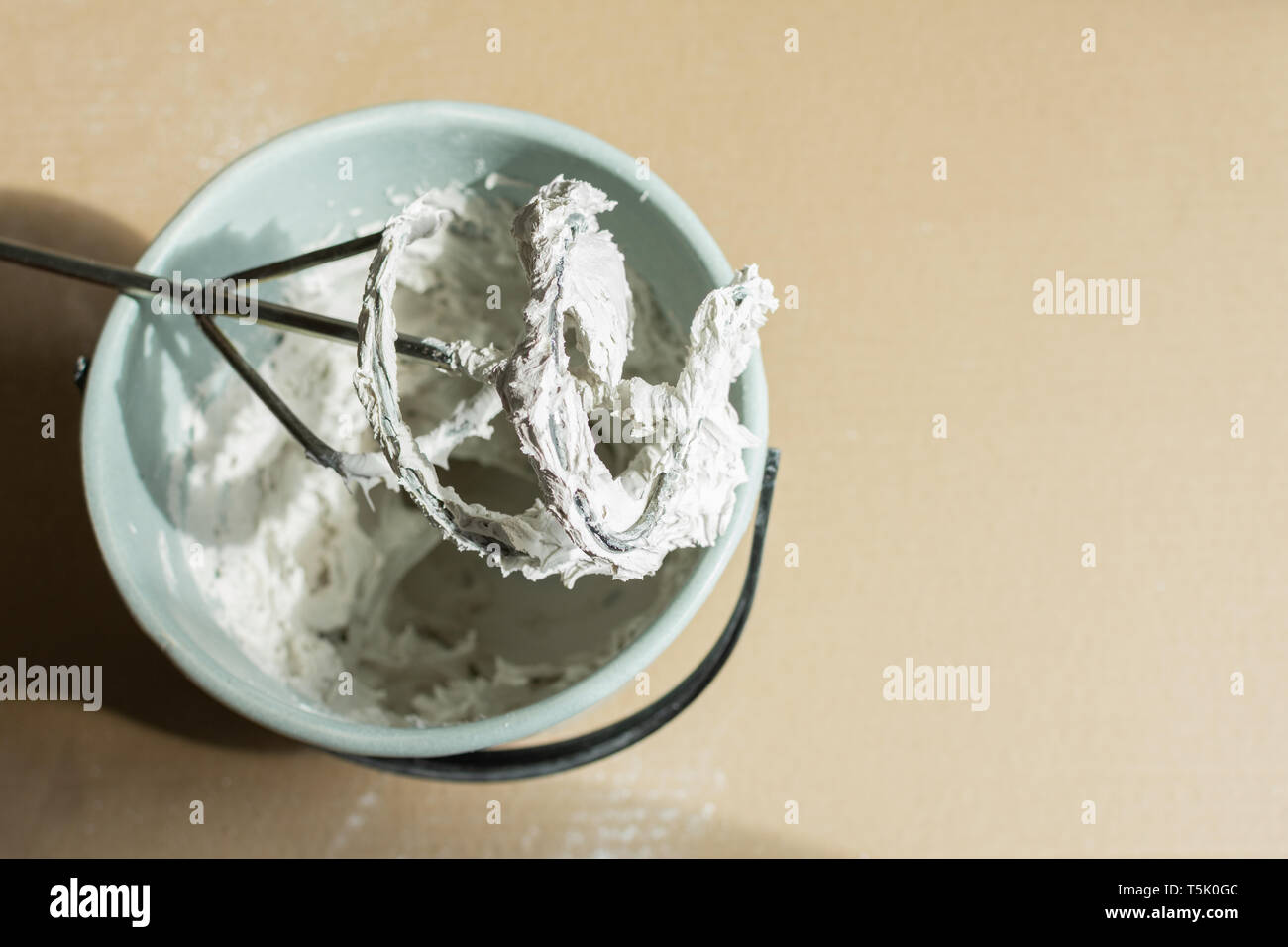 Bucket with ready putty and drill mixer Stock Photo - Alamy