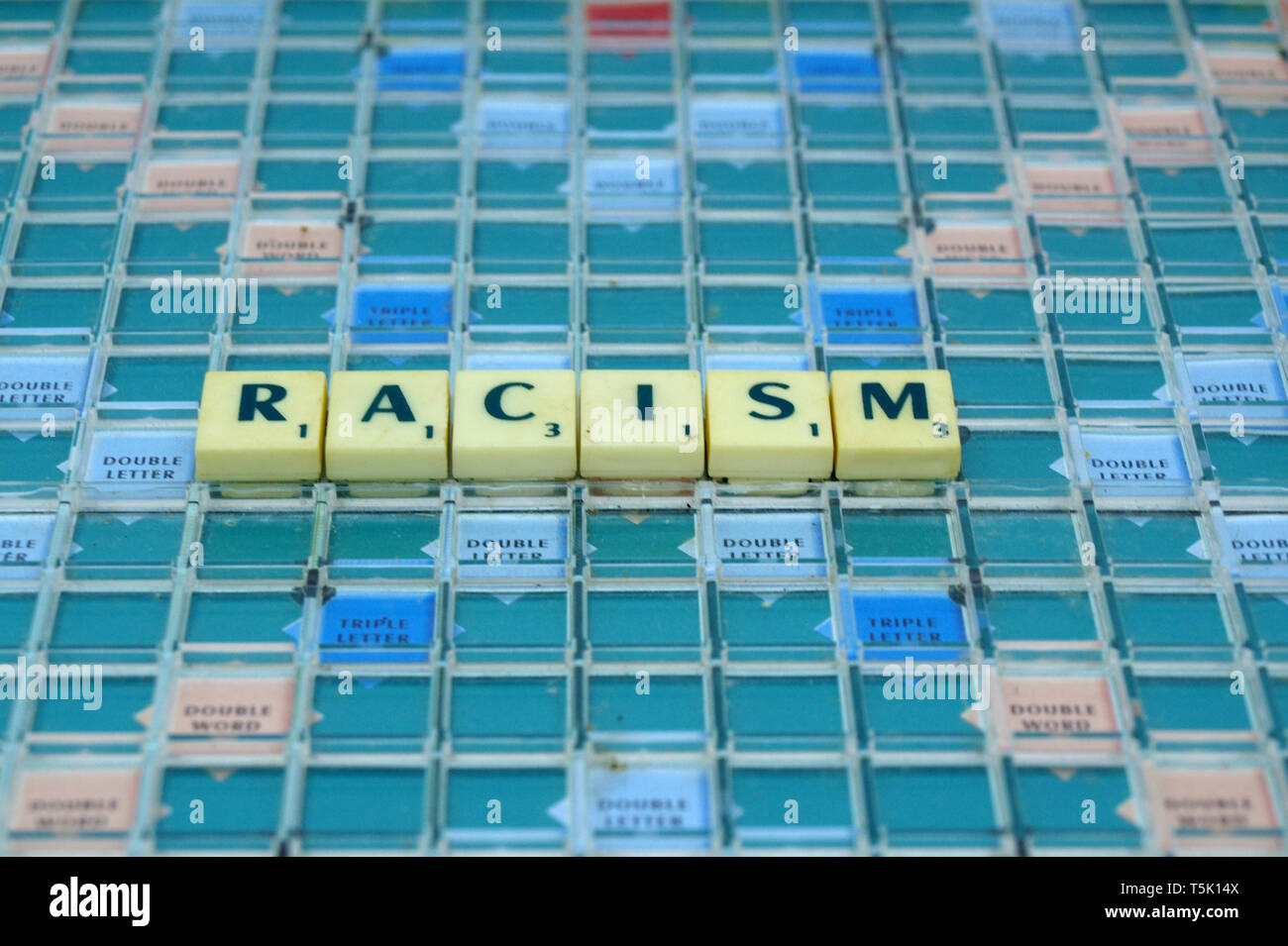 Racism written in Scrabble tiles Stock Photo - Alamy