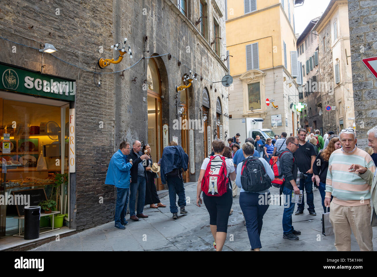 Siena city centre and tourists exploring the narrow streets of this ...