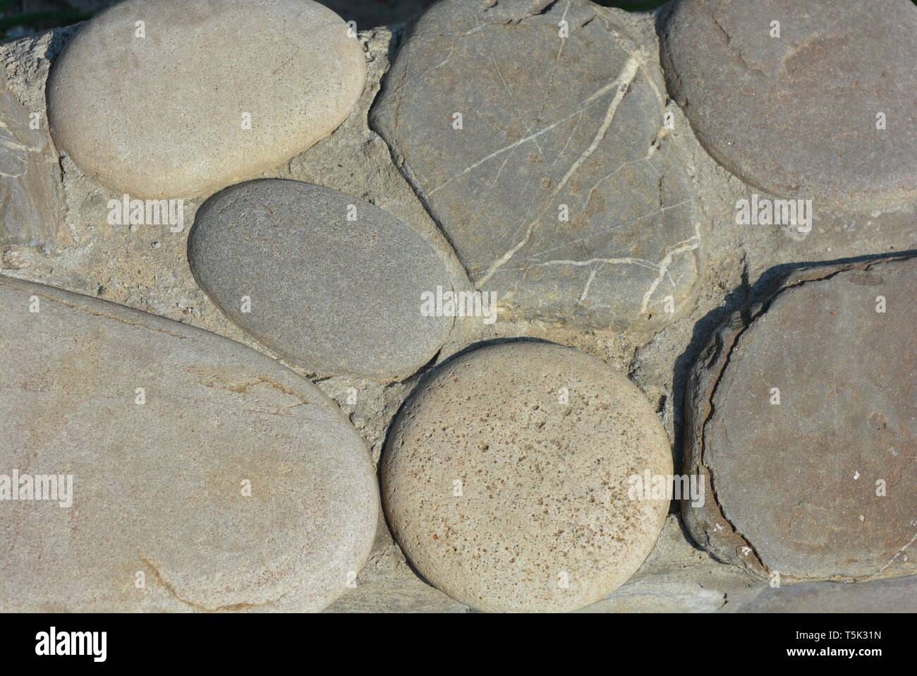 Large smooth sea stones with cement, original architectural background ...