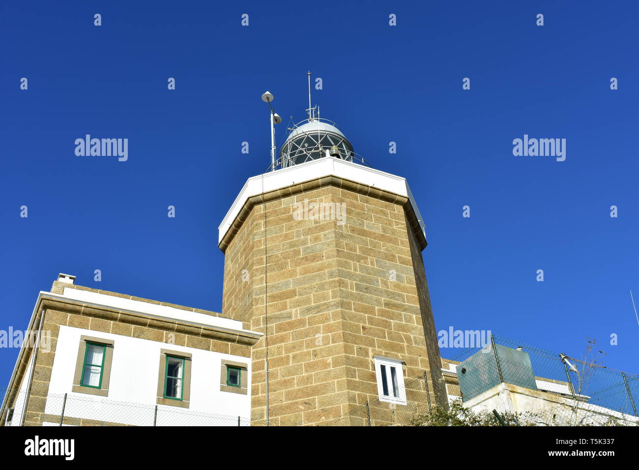 Finisterre lighthouse with blue sky, final stage of Camino de Santiago ...
