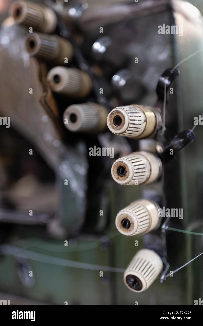 dirt encrusted knobs on an overlock sewing machine Stock Photo - Alamy
