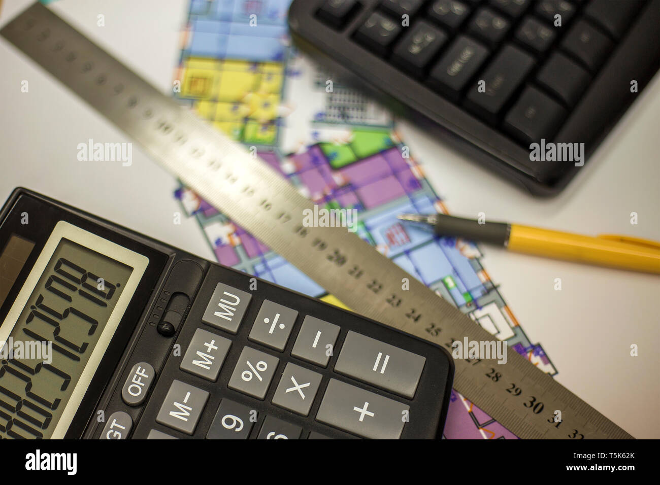 Top view of calculator, pen and ruler on blueprint plan of architecture ...