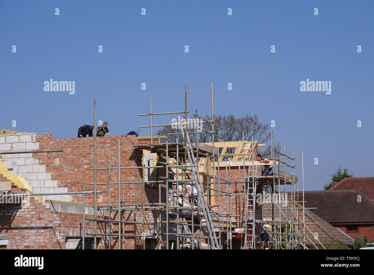 Workers building a house Stock Photo - Alamy