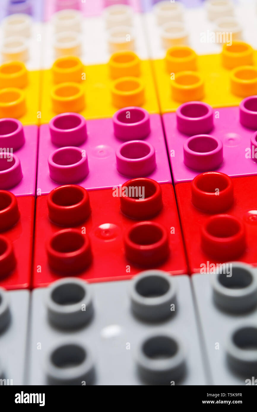 Plastic colorful toy constructor background. Child toy geometric bricks ...