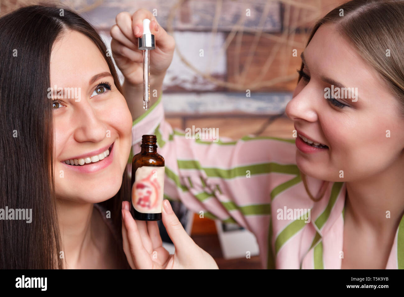 Beautiful cute smiling girls in pajamas advertise putting moisturizing ...