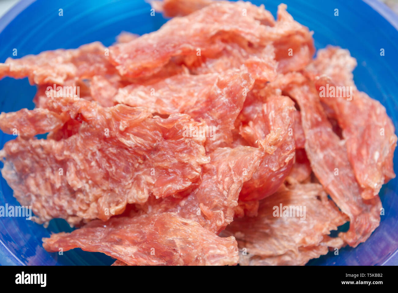 Dried meat 100 grams lies on plastic scales Stock Photo - Alamy