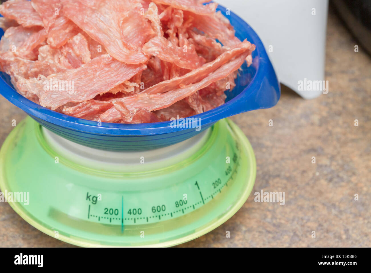 Dried meat 300 grams lies on plastic scales Stock Photo - Alamy