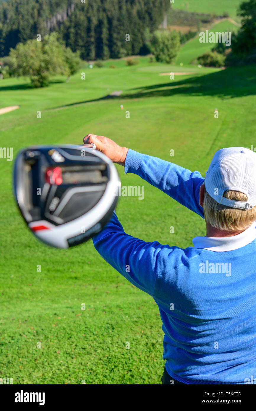 Golf player hitting a ball Stock Photo - Alamy